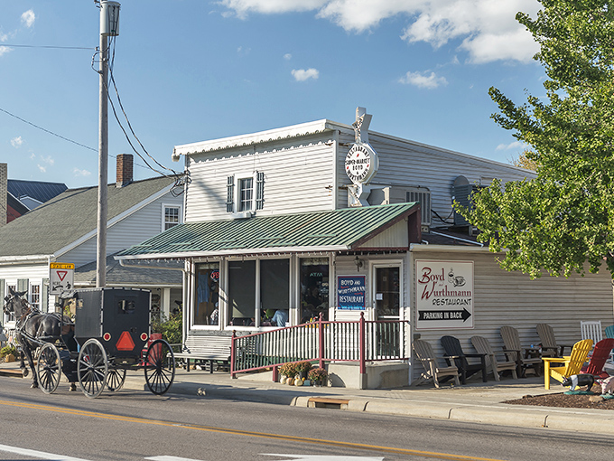 Where time stands still but hunger doesn't. The classic white clapboard exterior of Boyd & Wurthmann welcomes visitors while Amish buggies pass by, a scene straight from simpler times.