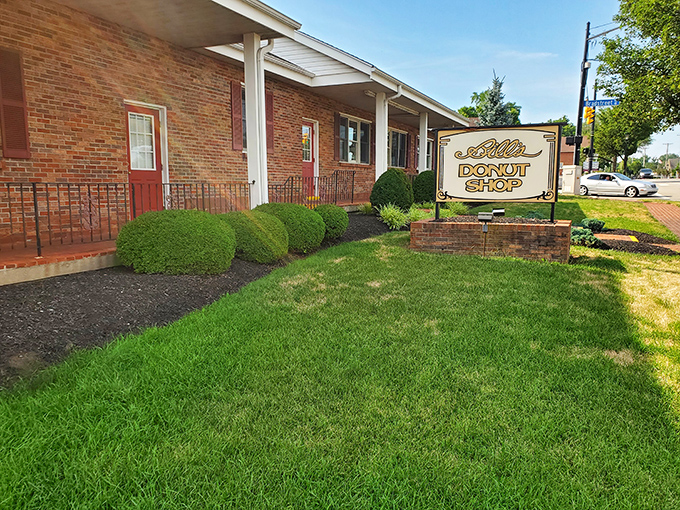 The brick facade whispers promises of sweet treasures waiting inside this beloved neighborhood institution.