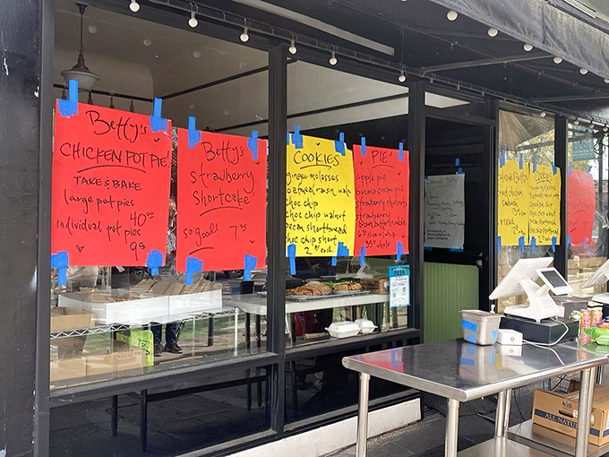The unassuming storefront of Bakesale Betty, where handwritten menu signs taped to windows tell you everything you need to know: greatness awaits inside.