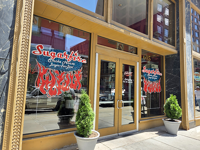 The golden-framed entrance to Sugarfire beckons like a portal to meat paradise. Those flames on the logo? A delicious warning of what's to come.