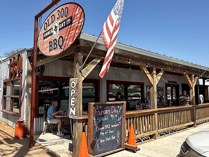 The Texas flag waves a hearty welcome outside Old 300 BBQ, where that wooden porch practically begs you to sit a spell after filling up on smoky goodness.