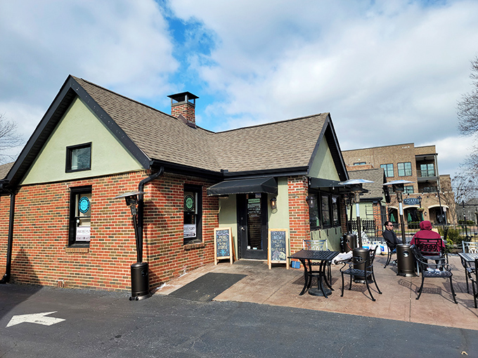 The charming brick exterior of Gracious Plenty beckons with its inviting patio—proof that breakfast paradise often comes in unassuming packages.