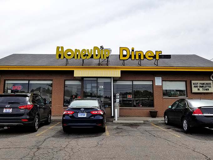 The bright yellow HoneyDip sign beckons like a breakfast lighthouse, guiding hungry souls to this Columbus institution where calories don't count before noon.