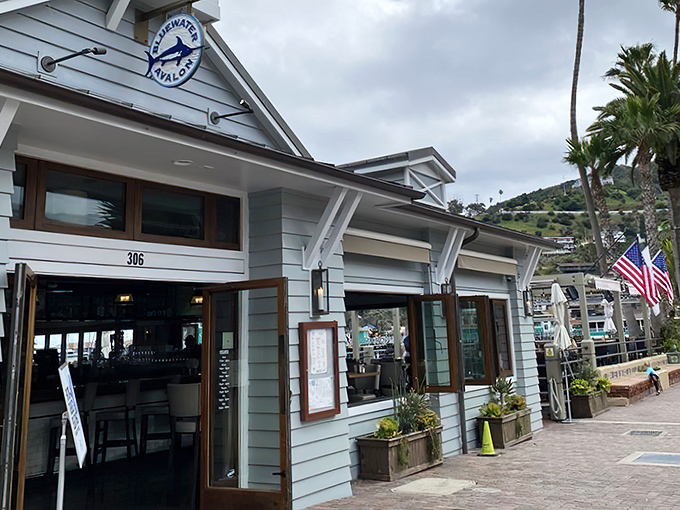 The crisp white exterior of Bluewater Avalon beckons like a maritime mirage, promising seafood treasures within its nautical-themed walls.