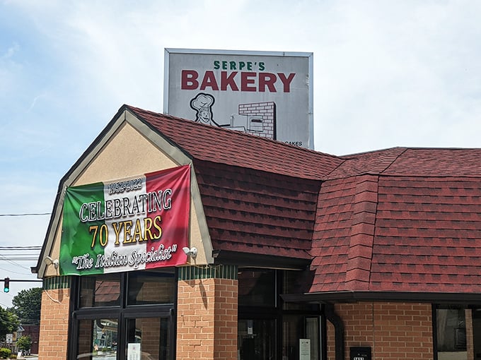 The iconic Serpe's Bakery exterior, with its distinctive red roof and Italian flag banner, stands as a Delaware landmark that's been satisfying sweet tooths for generations.