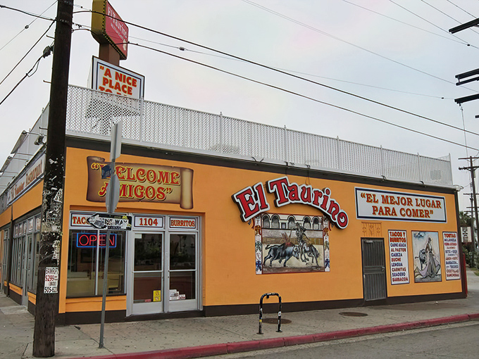 The unassuming salmon-pink exterior of El Taurino might not scream "food destination," but that bullfighting mural is your first clue to culinary greatness within.