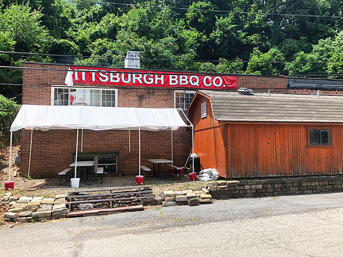 The bright red exterior of Pittsburgh BBQ Co. stands out like a beacon of smoky promise against Pennsylvania's green hillside.
