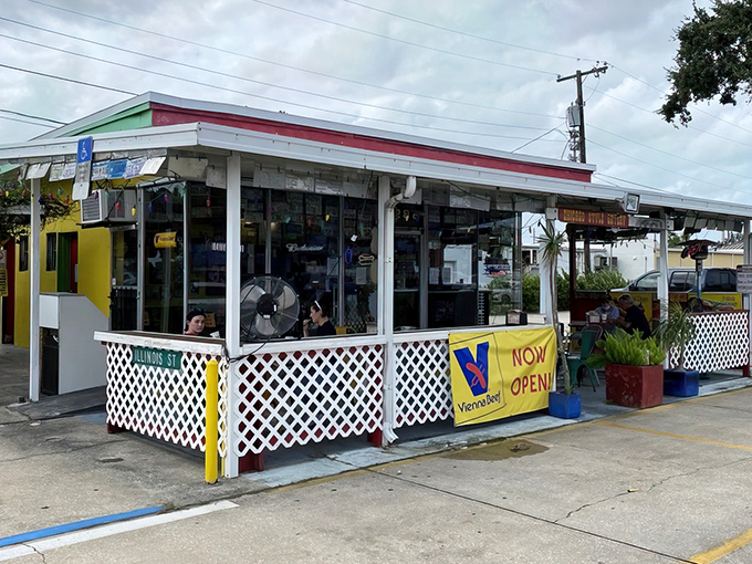 The unassuming exterior of Mustard's Famous Hot Dogs hides a culinary treasure that proves the best things come in small, yellow-trimmed packages.