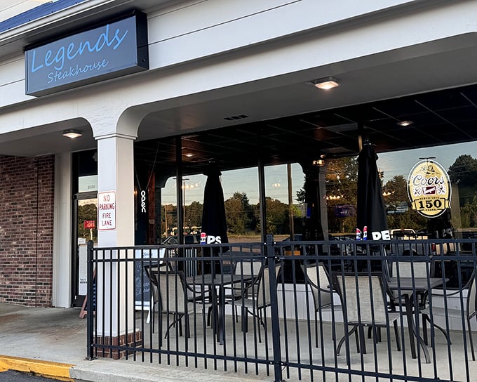 The blue sign beckons like a lighthouse for hungry souls. Legends Steakhouse's modest exterior hides culinary treasures within.