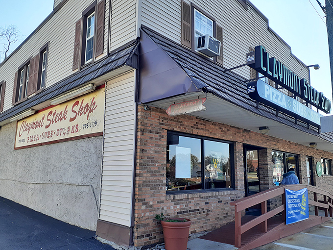 The unassuming exterior of Claymont Steak Shop stands like a culinary lighthouse, beckoning sandwich pilgrims from miles around with its no-nonsense charm.