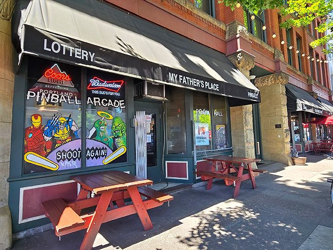 The unassuming storefront of My Father's Place beckons with its classic red picnic tables and vintage signage, promising comfort food without pretension.