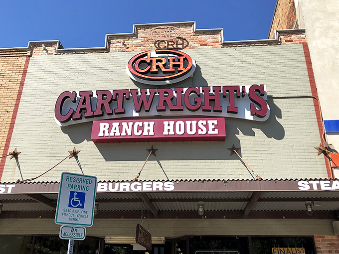 The iconic Cartwright's Ranch House sign stands proudly against the Texas sky, a beacon for hungry souls seeking comfort food salvation.