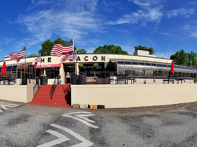 The chrome-clad exterior of The Beacon shines like a culinary lighthouse in Spartanburg, complete with American flags proudly waving visitors toward burger paradise.