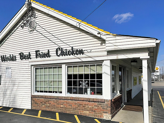 Bold white lettering against classic siding proudly declares what locals already know – this modest building houses chicken perfection worth crossing roads for.