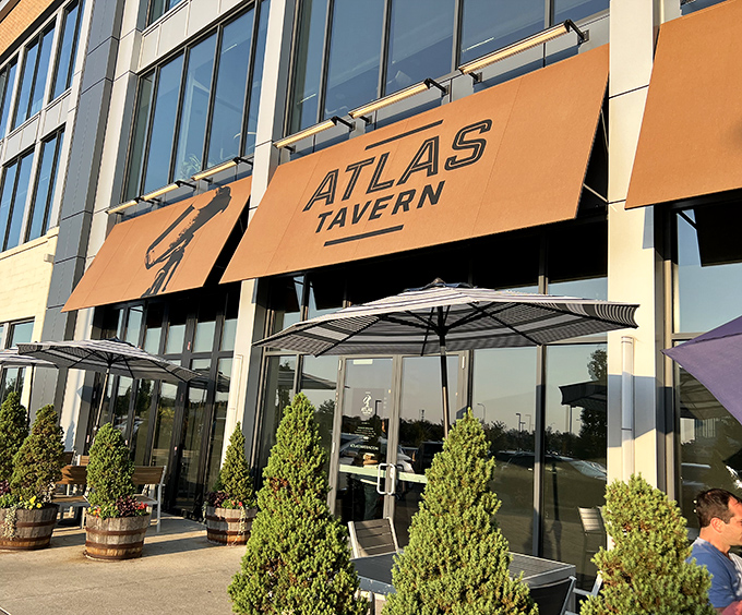 Atlas Tavern's distinctive yellow awnings beckon hungry travelers like a lighthouse guiding ships to harbor. Modern meets comfortable in this Columbus hotspot.