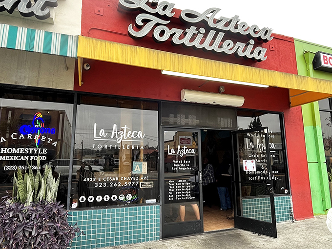 The vibrant red and yellow fa&ccedil;ade of La Azteca Tortilleria stands like a beacon of culinary promise on Cesar Chavez Avenue.