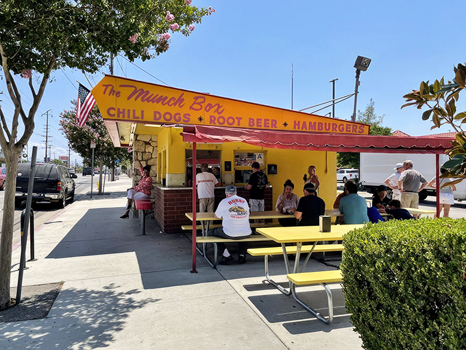 The sunshine-yellow landmark stands proudly in Chatsworth, its red awning and picnic tables inviting hungry patrons to experience a slice of California fast-food history.