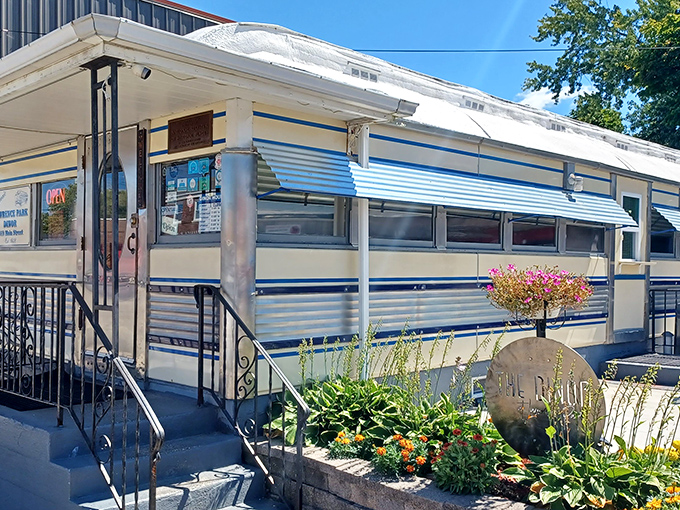 The classic railcar silhouette of Lawrence Park Dinor stands proudly in Erie, promising comfort food treasures behind its unassuming blue-trimmed exterior.