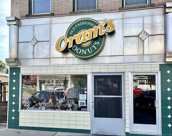 The iconic yellow and green Oram's sign beckons donut lovers like a sugary lighthouse in Beaver Falls. Old-fashioned indeed, but timeless in its appeal.