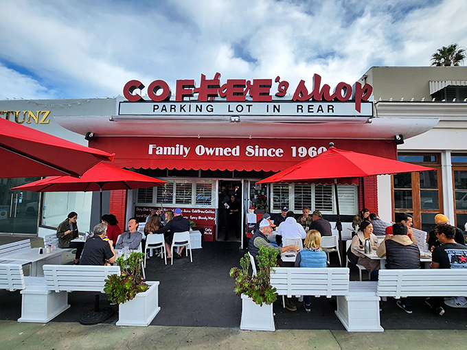 That red awning beckons like a lighthouse for hungry souls seeking authentic diner magic in La Jolla.