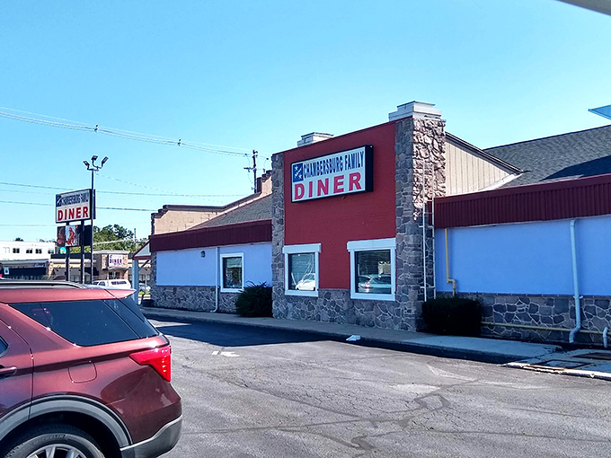 The iconic red and stone exterior of Sunrise Diner stands as a beacon for hungry travelers. Classic Americana at its finest!