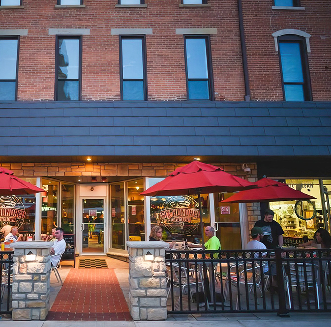The historic brick fa&ccedil;ade of Six Hundred Downtown welcomes pizza pilgrims with its cheerful red umbrellas and inviting patio seating.