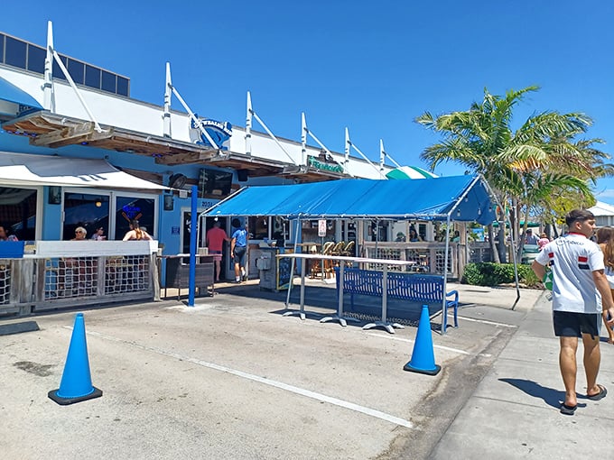 The blue-hued exterior of The Whale's Rib stands like a maritime beacon for hungry beachgoers, complete with nautical flags that practically scream "fresh seafood inside!"