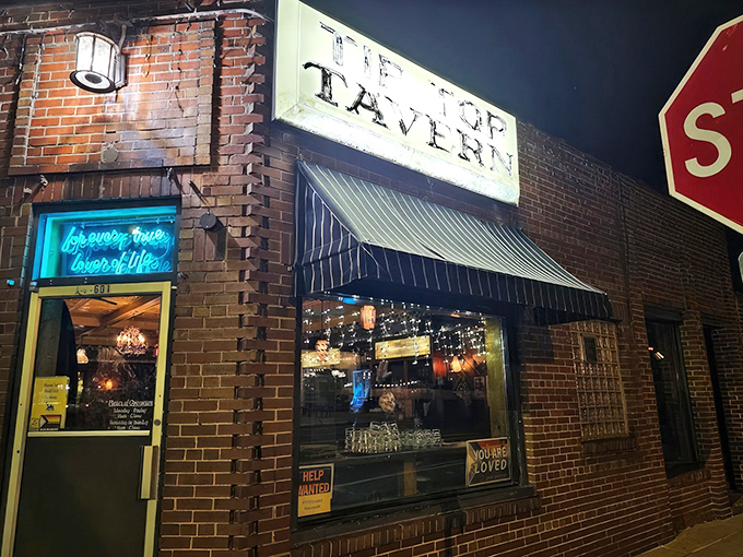 The unassuming brick exterior of Tip Top Tavern stands like a culinary sentinel at the corner, promising delights that belie its modest appearance.