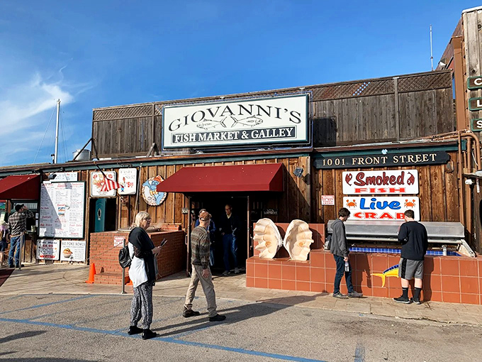 Giovanni's wooden exterior welcomes seafood pilgrims with the promise of oceanic treasures, while Morro Rock stands guard in the background like a culinary lighthouse.