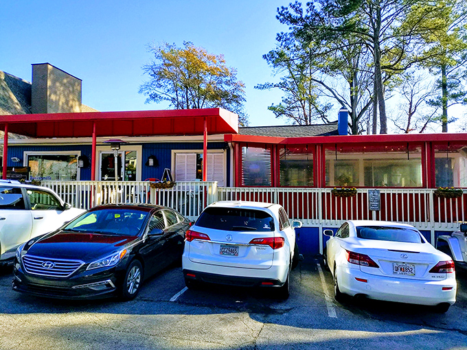 The blue cottage with its striking red awnings stands like a breakfast beacon in Buckhead, promising morning delights worth any wait.