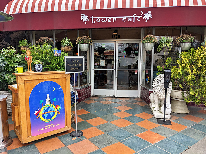 The entrance to Tower Caf&eacute; feels like stumbling upon a secret garden oasis, complete with guardian statues and a red awning that practically winks at you.