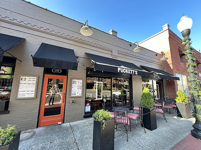 Puckett's storefront glows with Southern hospitality after dark, beckoning hungry travelers like a lighthouse for comfort food enthusiasts.
