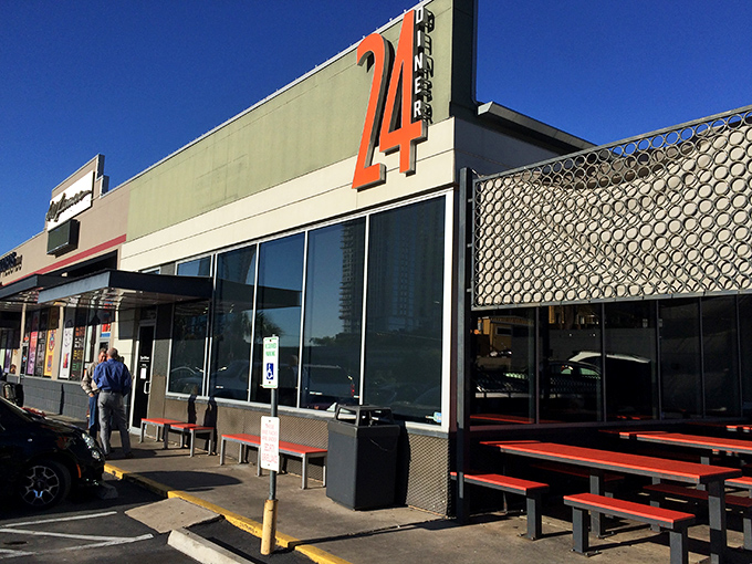 That iconic orange "24" sign isn't just a number&mdash;it's a beacon of hope for hungry souls at all hours. Austin's modern diner stands ready to serve.