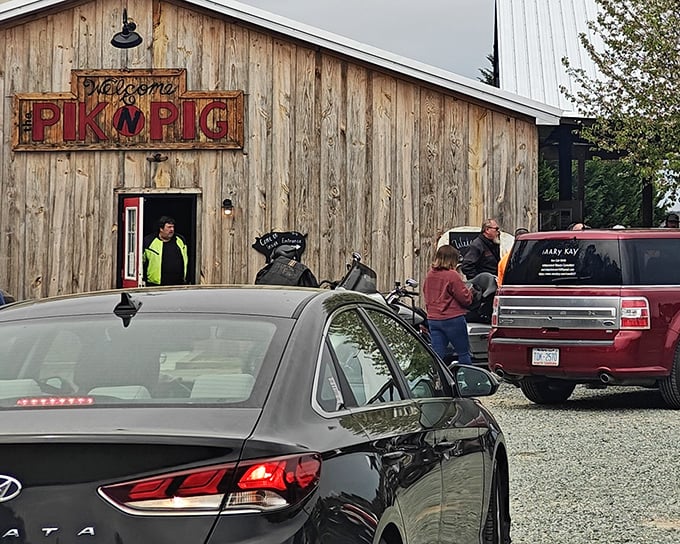 Rustic charm meets serious barbecue at this weathered barn with its distinctive red door. The Pik N Pig sign promises delicious things await inside.