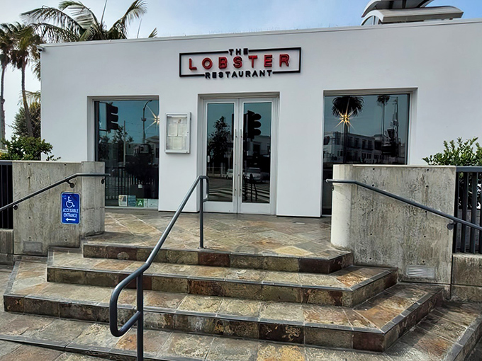 The pristine white exterior of The Lobster stands like a culinary lighthouse at the entrance to Santa Monica Pier, beckoning seafood lovers home.