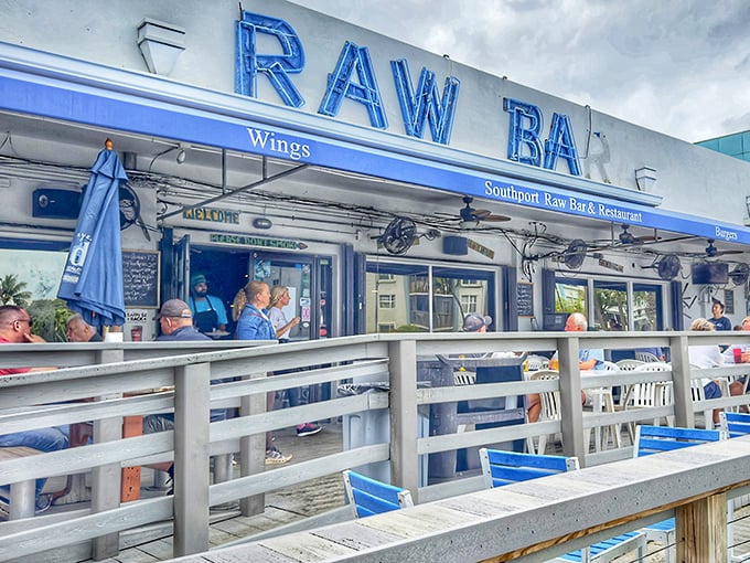 The iconic blue "RAW BAR" sign beckons seafood lovers like a maritime lighthouse. This waterfront deck promises the kind of authentic Florida experience you can taste.