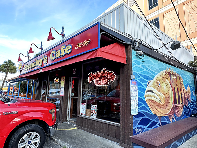 Frenchy's iconic exterior beckons seafood lovers with its vibrant red awning and unmistakable grouper mural &ndash; the Florida equivalent of a lighthouse for hungry sailors.