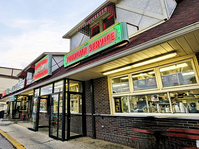The neon "FOUNTAIN SERVICE" sign glows like a beacon from another era, promising simple pleasures that never go out of style.