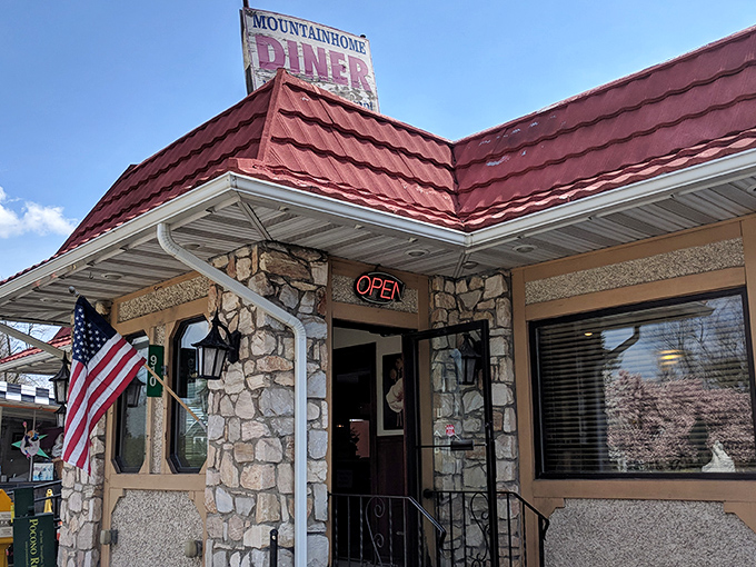 The stone facade and glowing "OPEN" sign beckon like an old friend. This unassuming exterior hides breakfast treasures that locals have cherished for generations.
