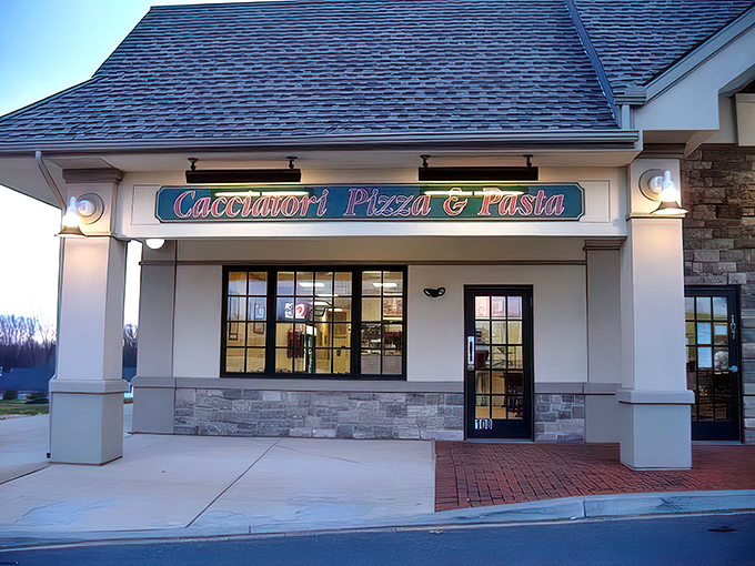 The welcoming storefront of Cacciatori Pizza & Pasta beckons with its warm brick facade and inviting entrance, promising Italian comfort within.