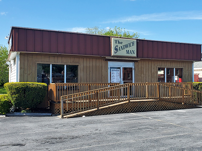 The unassuming wooden exterior of Sandwich Man might not scream "culinary destination," but locals know this humble facade hides sandwich greatness within.