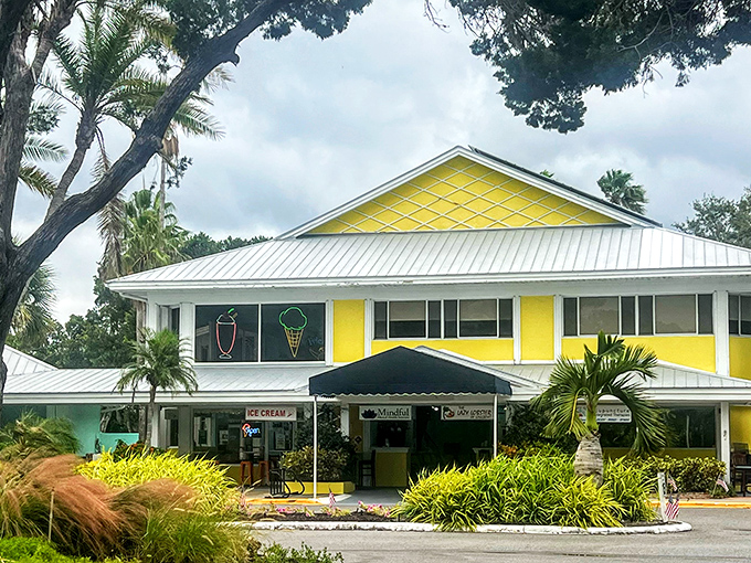 The cheerful yellow exterior of Lazy Lobster beckons like Florida sunshine in building form, promising seafood treasures within its casual, palm-fringed setting.