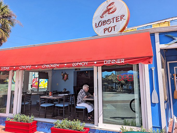 The iconic red awning and circular lobster sign beckon seafood lovers like a lighthouse guides ships home to New England shores. 