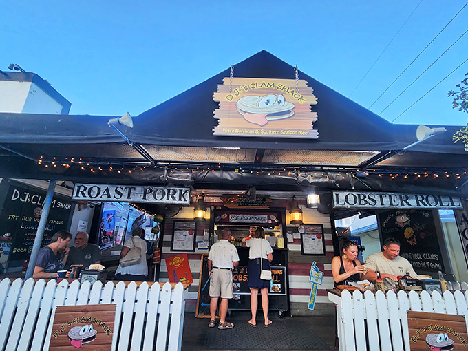 The unassuming facade of DJ's Clam Shack beckons seafood lovers with its charming white picket fence and promise of lobster roll nirvana.