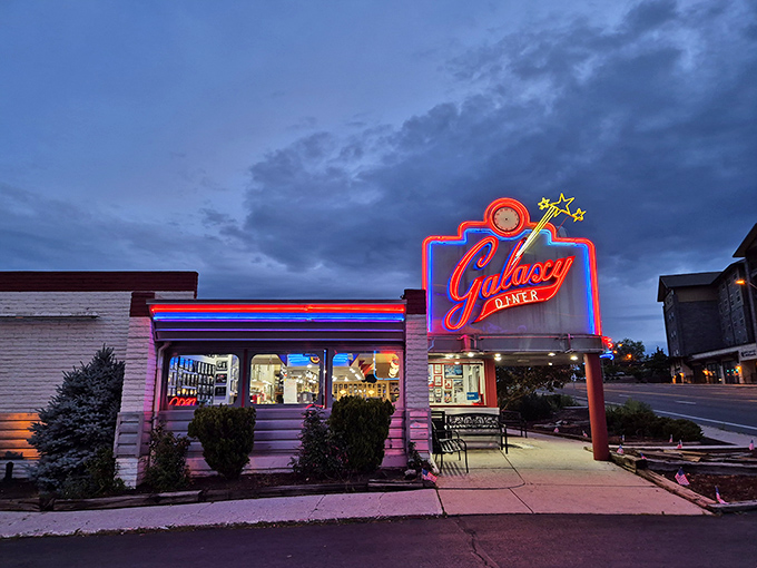 That neon glow against the twilight sky isn't just a sign&mdash;it's a time machine beckoning you to simpler days when calories didn't count and jukeboxes ruled.