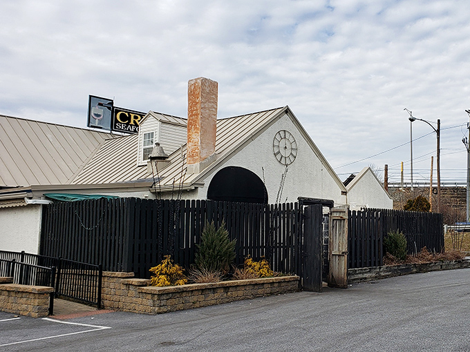 Twilight transforms Creed's into a glowing beacon of culinary promise, its distinctive clock face and twinkling lights beckoning hungry travelers like a gastronomic lighthouse.