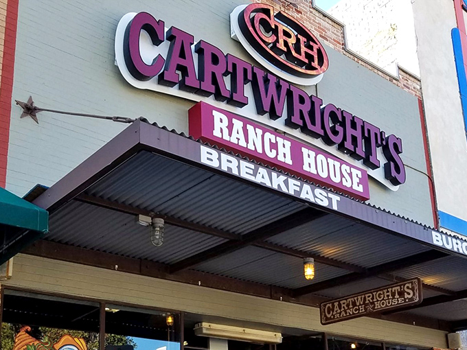 The purple sign beckons like a Texas-sized promise &ndash; Cartwright's Ranch House isn't just a restaurant, it's a declaration of comfort food devotion.