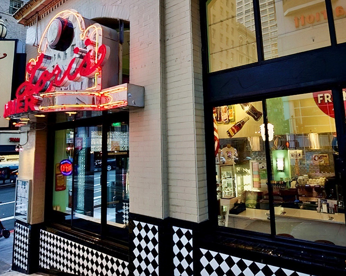 The neon promise of Lori's Diner glows against San Francisco's urban landscape, a beacon of retro comfort in a sea of modern hustle.