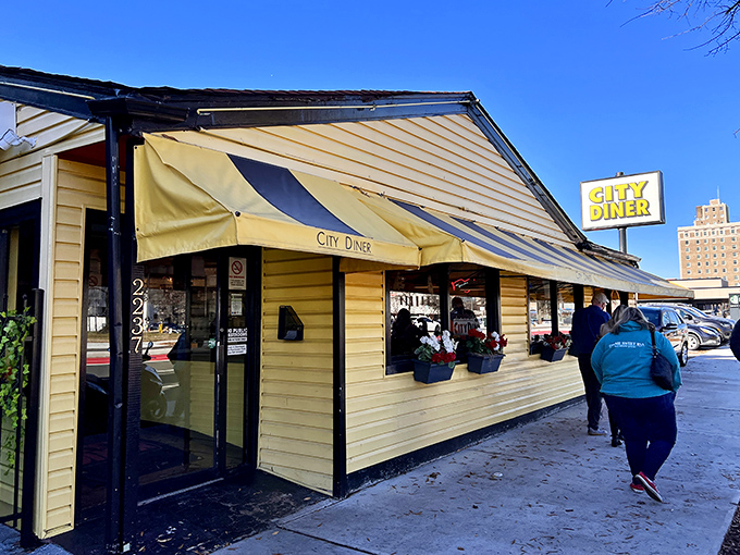 The sunshine-yellow exterior of City Diner stands like a beacon of breakfast hope on Broad Street, promising comfort food salvation to hungry Richmonders.