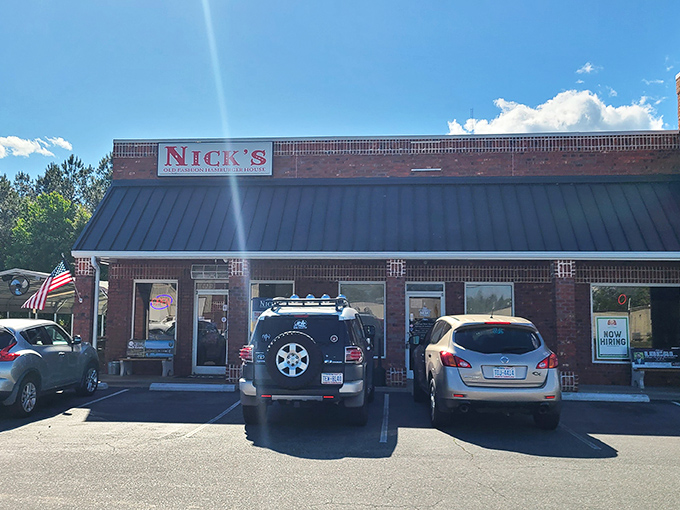 The brick fortress of flavor stands ready, American flag waving like a beacon for hungry souls seeking burger salvation.